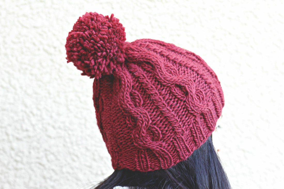 Knit hat for women in wine red color with cables and pompom – KGThreads